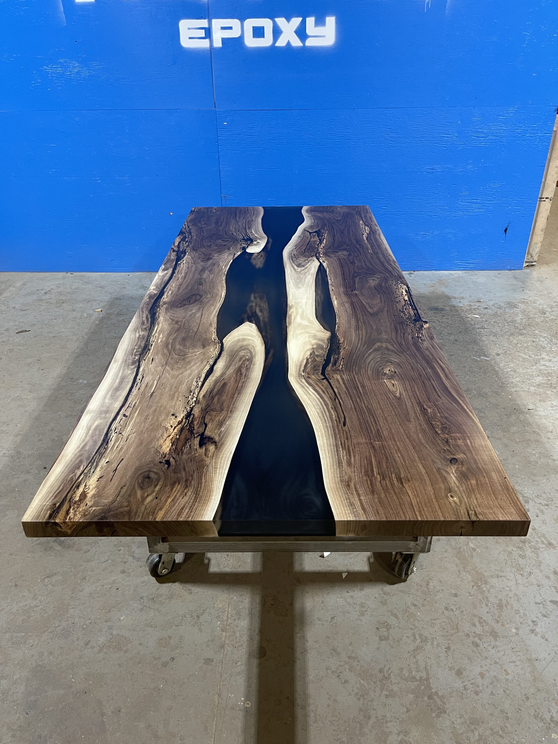 Walnut dining table with clear epoxy over dark grey base - Anglewood ...